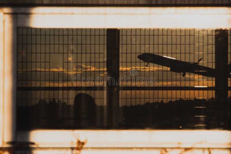 The Reflection that an Airplane Taking Off in Sunset Stock Image ...