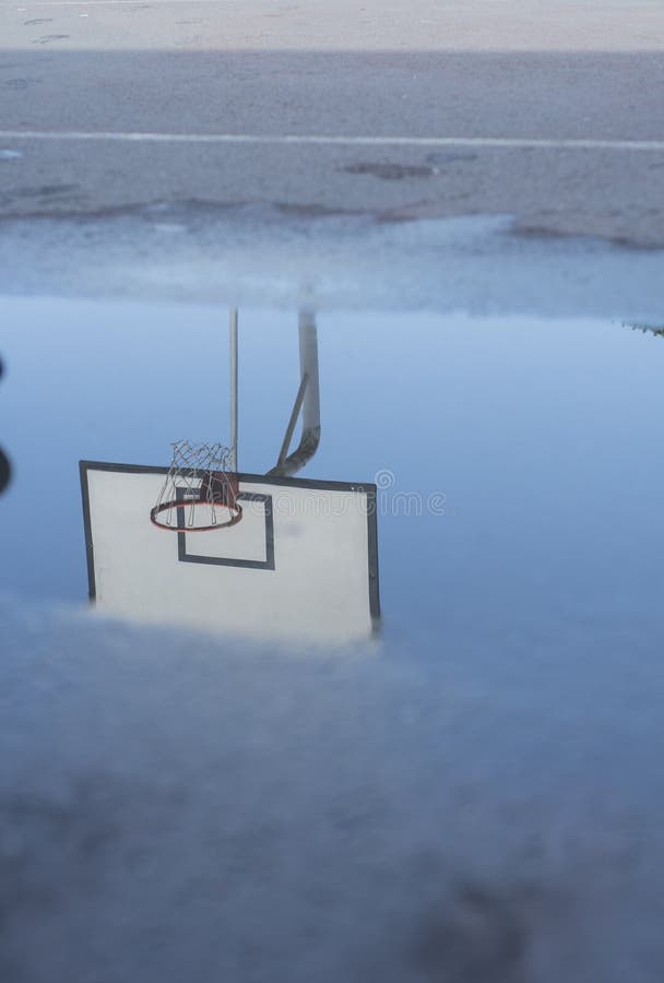 Reflection of a Basketball Ring in a Puddle after the Rain Stock Photo ...