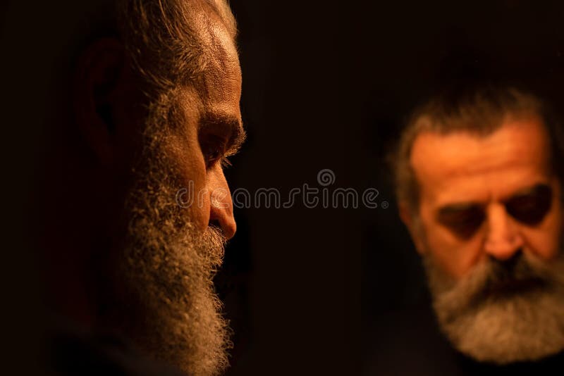 Reflection of Bearded Man in a Dark, with Painful Expression on His ...