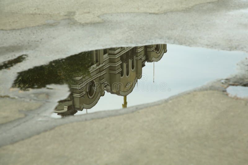 Reflection of Beautiful Building in Puddle on Asphalt Stock Photo ...