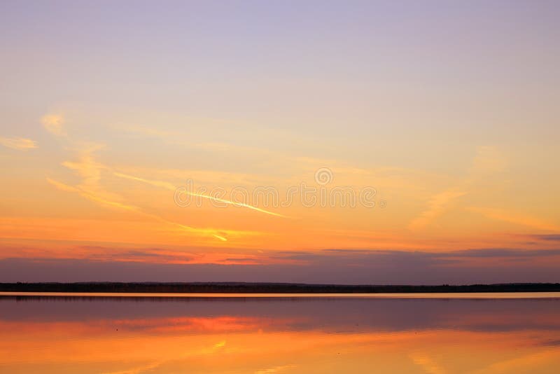 Reflection of a Beautiful Sunset Over the Water Stock Photo - Image of ...