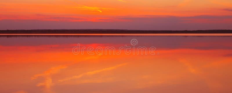 Reflection of a Beautiful Sunset Over the Water Stock Photo - Image of ...