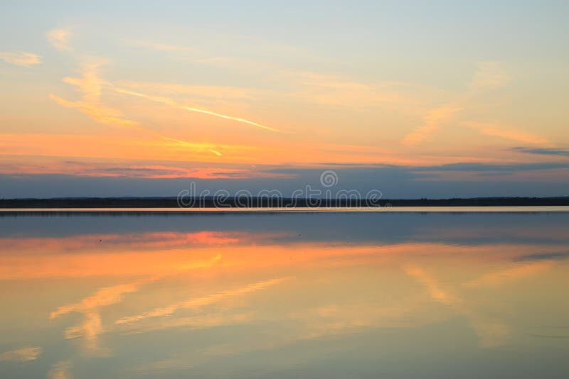 Reflection of a Beautiful Sunset Over the Water Stock Photo - Image of ...