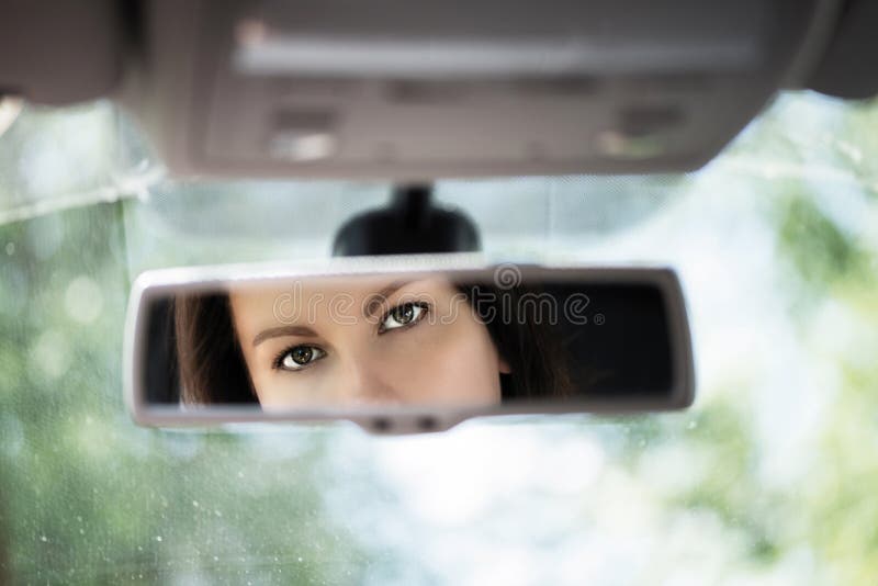 Reflection of a Beautiful Young Woman Face in the Car Rear View Mirror ... Reflection of a Beautiful Young Woman Face in the Car Rear View Mirror ...