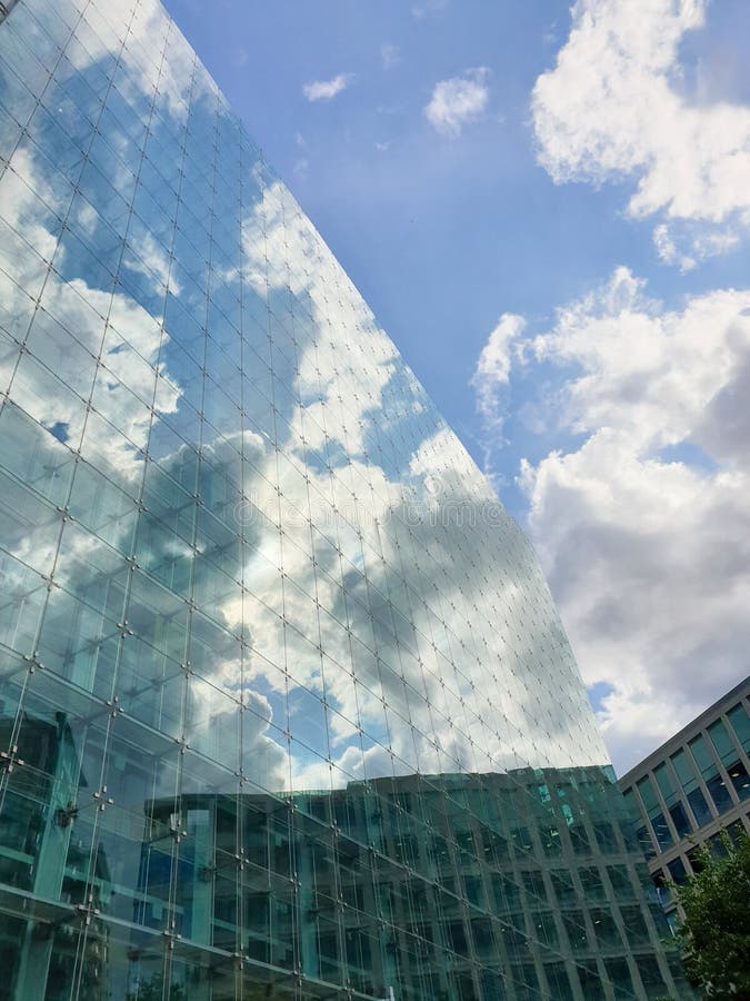 Reflection of Blue Sky and Clouds on the Glass Facade of Modern ...