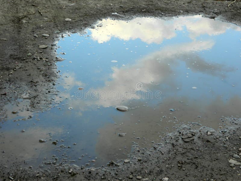 Reflection of Blue Sky with Clouds in a Puddle Stock Image - Image of ...