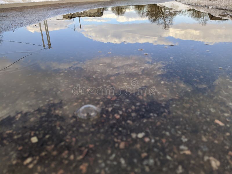 Reflection of Blue Sky and White Clouds in a Puddle. Stock Image ...