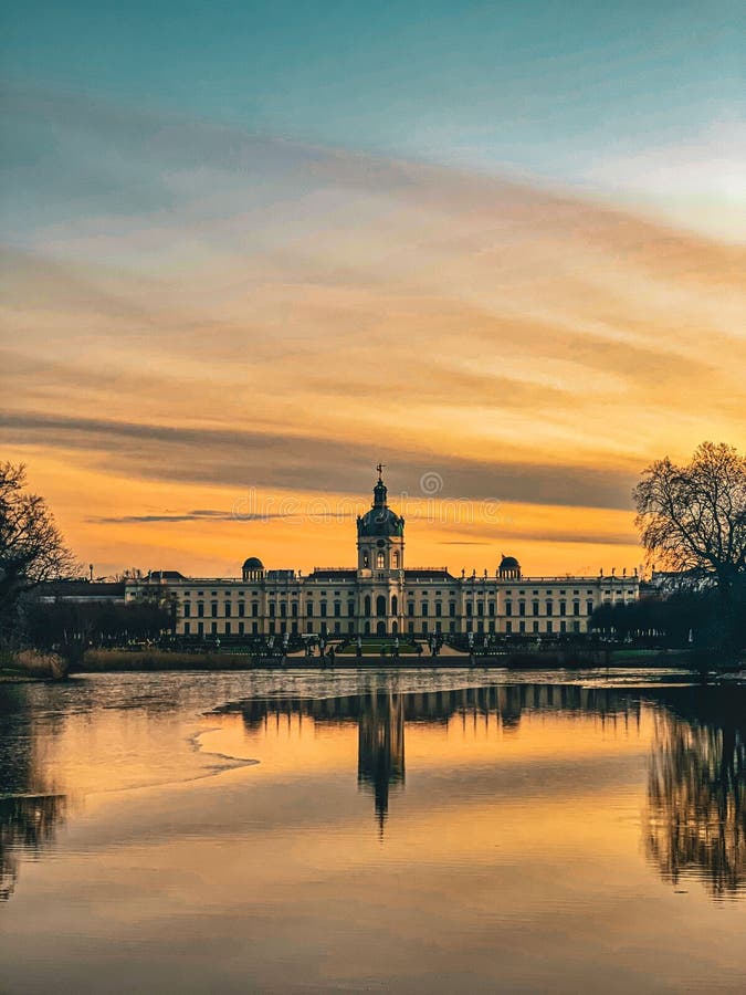The Reflection of a Building in a Lake with Trees in Front Editorial ...