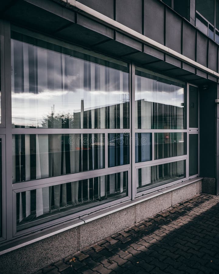 The Reflection of a Building is in a Store Window at Dusk Stock ...