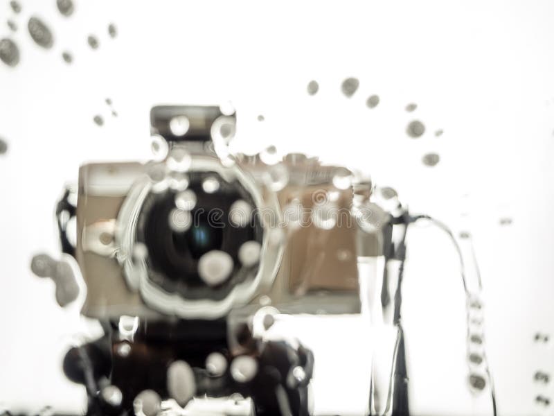 A Retro Camera with a Metal Body with a Strap Lies on a Gray Background ...