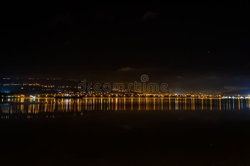 Reflection of City Lights at Night Over a Lake Stock Image - Image of ...