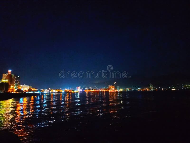 The Reflection of City Lights in the Sea Stock Photo - Image of ...