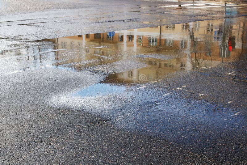 Reflection of City in Puddle on Pavement Stock Photo - Image of blue ...