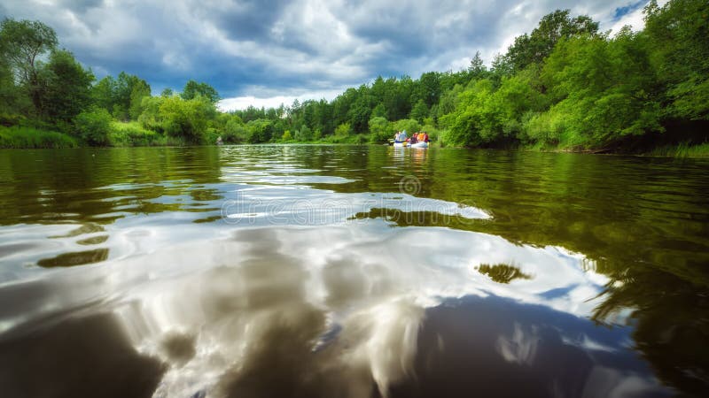 Reflection of Clouds in Beautiful River and People on Catamaran ...