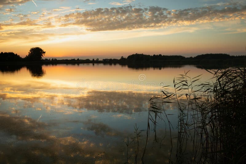 Reflection of Clouds in the Lake Water after Sunset Stock Photo - Image ...