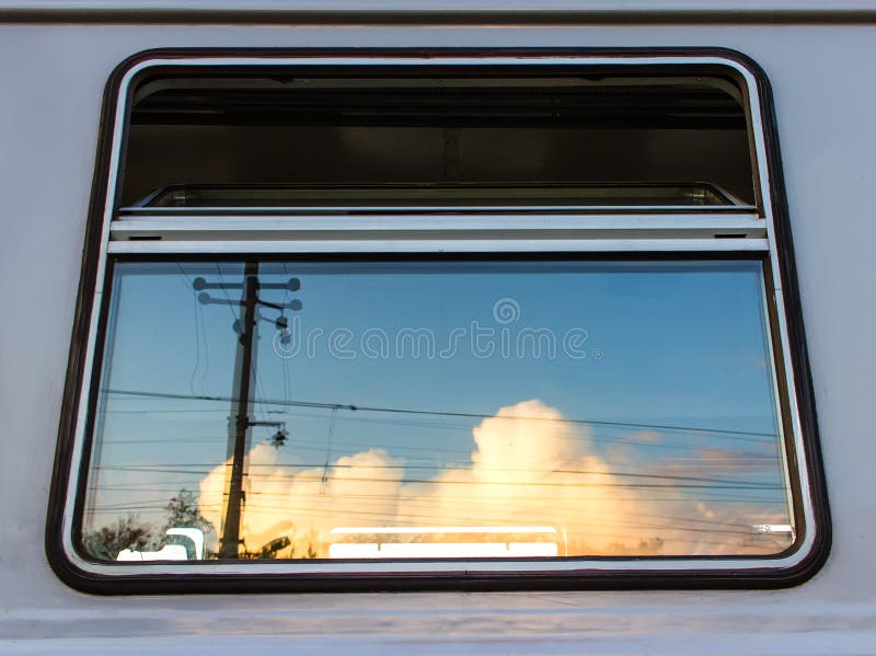 Reflection of the Clouds and Pillar of the Train Window Stock Photo ...