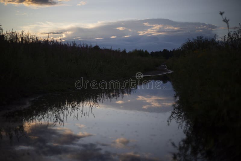 Reflection of Clouds in Water. Mirror Puddle. Reflection of the Sky in ...