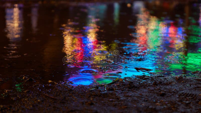 Reflection of Colorful Lights in Puddle As a Background Stock Image ...
