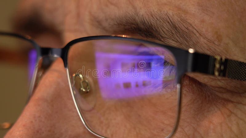 Reflection of the Computer Screen in Glasses. Elderly Man`s Eyes with ...