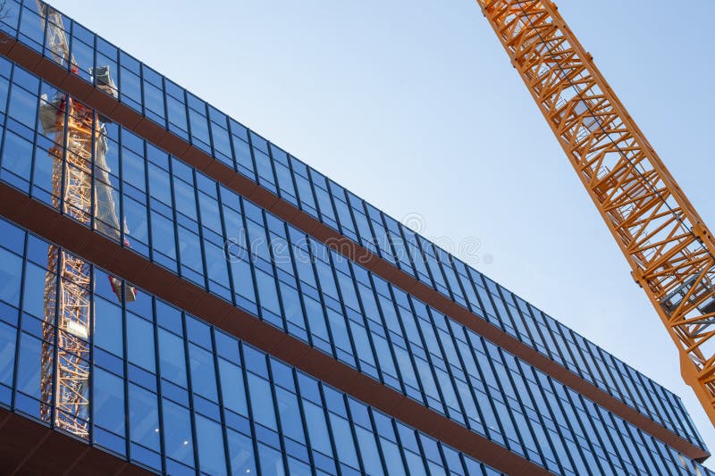 Reflection of Construction Crane in Modern Office Windows Stock Photo ...