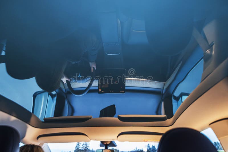Reflection of Driver and Dashboard Visible on Glass Roof Inside Tesla ...