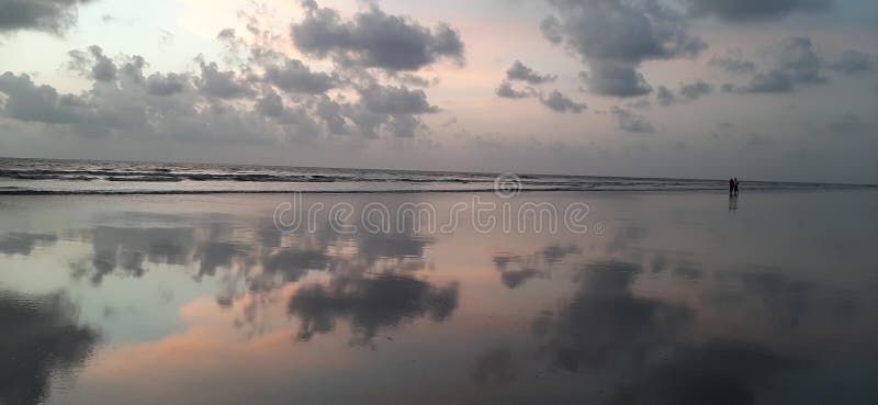 A Reflection of the Dynamic Sky on the Beach. a Sunset Stock Image ...