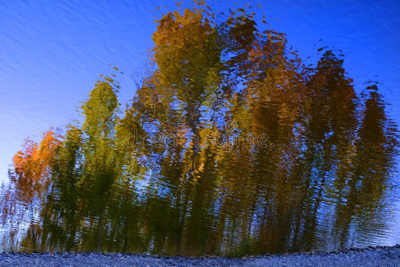 Reflection of Fall Trees in Blue Water Texture Stock Photo - Image of ...