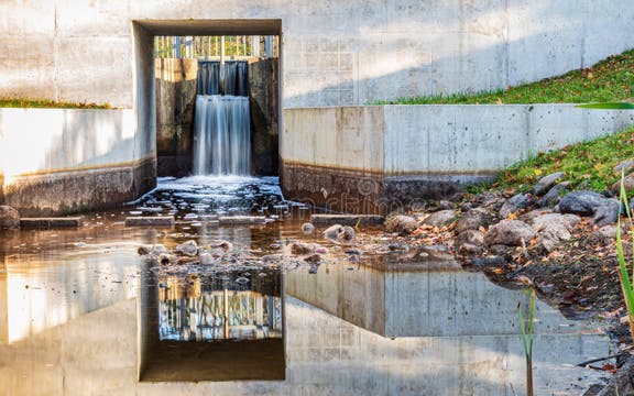 A Reflection of the Floodgates. a Reflection of the Waterfall in the ...