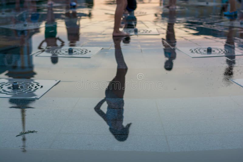 Reflection of a Girl in Water Fountains in the Square Stock Image ...
