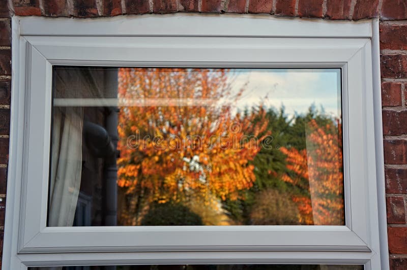 Modern UPVC Window Frame with Reflections of Fall Season Trees Stock ...