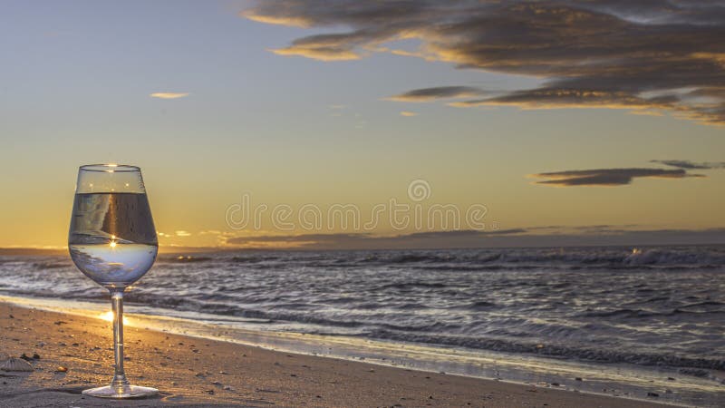 A Glass at Sunset on a Beach. Stock Image - Image of dawn, nature ...