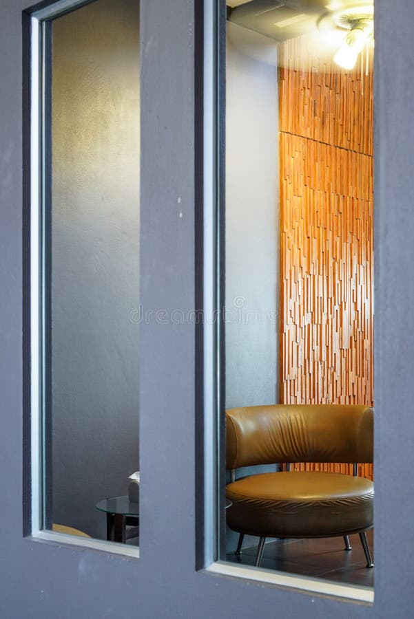Reflection of Living Room Corner with Brown Round Sofa and Gray Wall ...