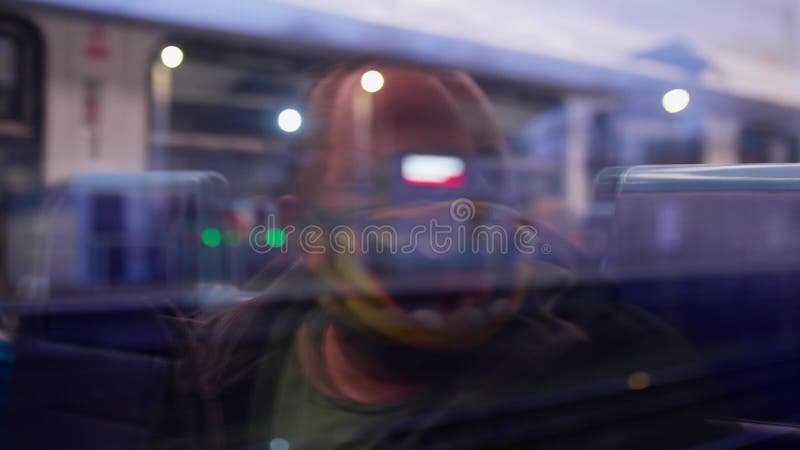 Reflection of Man in Mask in the Window of Moving Train. Russian ...
