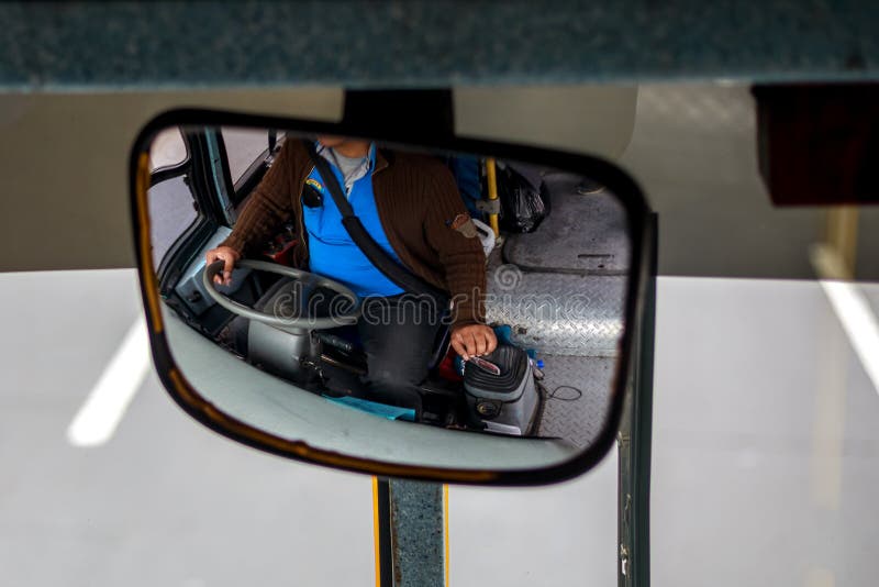 A Reflection into a Mirror of a Bus Man Driver in Lima, Peru during ...
