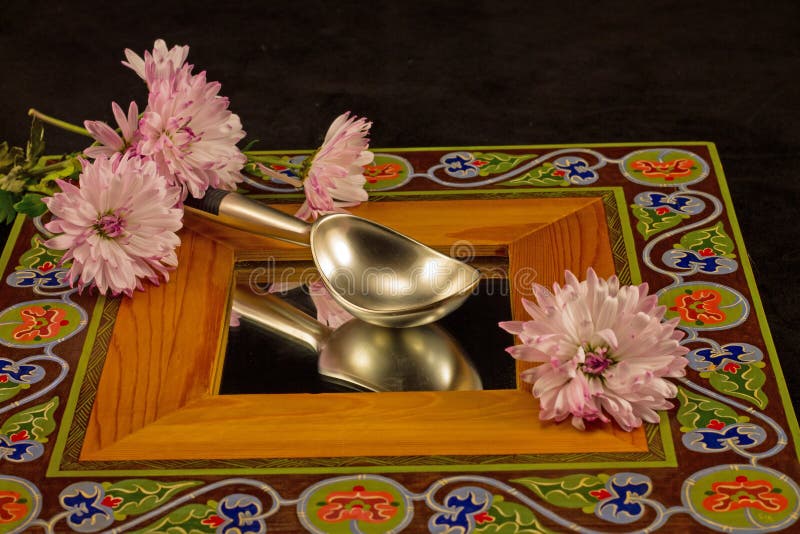 The Reflection in the Mirror Silver Spoon and Chrysanthemums Stock ...