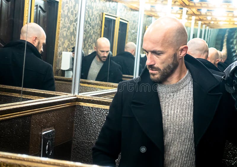 Reflection in the Mirrors of a Man. Portrait of a Man in a Black Coat ...