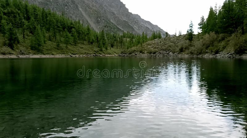 Reflection of Mountain Peaks in the Shaky Surface of a Beautiful Lake ...