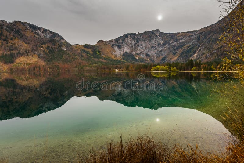 Reflection in the Mountains and Weak Sun in a Mountain Lake Stock Image ...