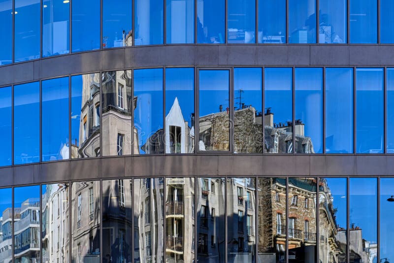 Reflection of the Old Buildings on the Windows of the Business Center ...