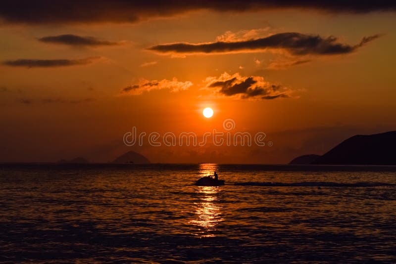 Reflection Path of Morning Sun in Ocean at Dawn with Clouds and Jet Ski ...