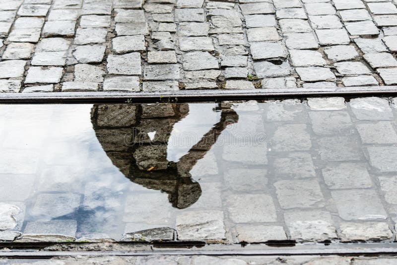 Reflection of Person and Bicycle in a Puddle of Rainwater in the River ...