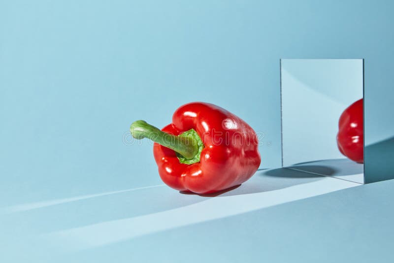 Sweet Red Pepper, a Square Mirror on a Blue Background, a Reflection of ...