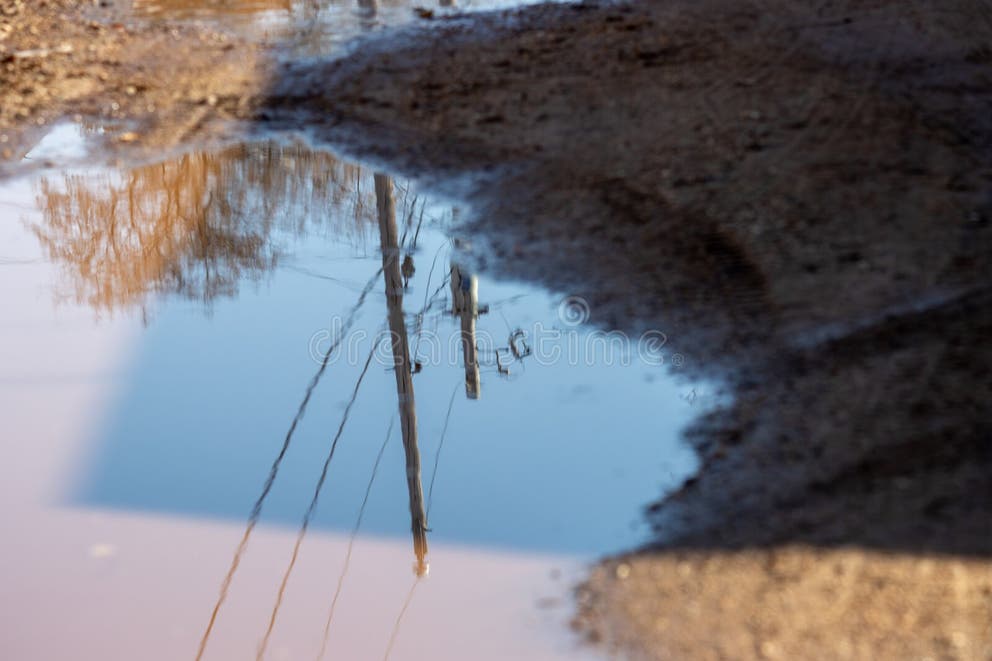 A Reflection of Power Lines in a Mud Puddle Stock Image - Image of ...