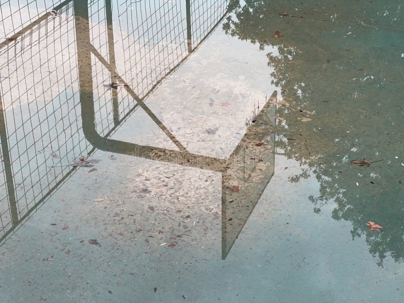 Reflection in a Puddle. Basketball Hoop. Wet Basketball Court Stock ...