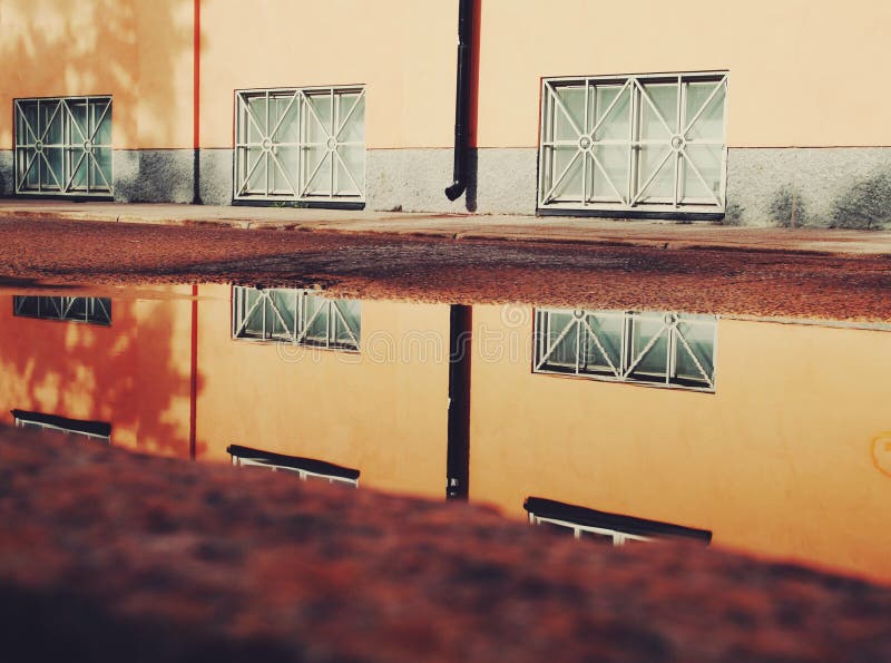 Reflection in a Puddle on City Street Stock Photo - Image of iron ...