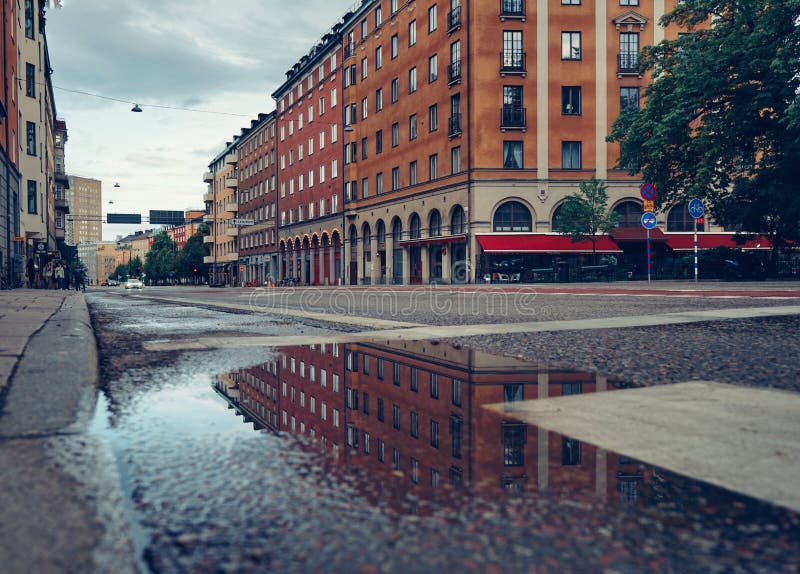Reflection in Puddle on Street in City Stock Photo - Image of street ...
