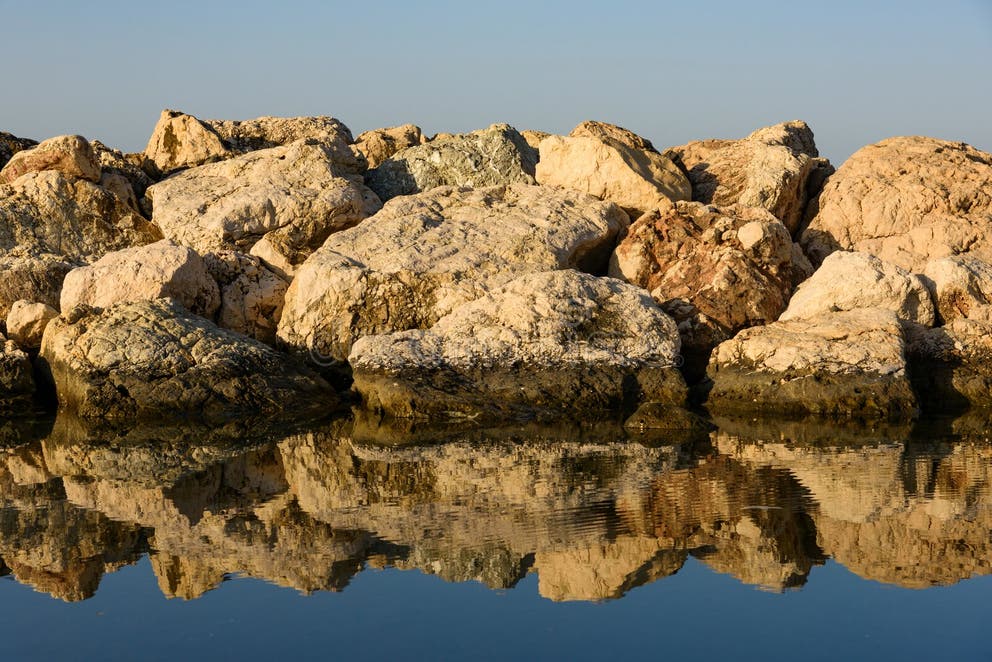 Reflection of Rocks on the Sea Stock Photo - Image of phenomenon, water ...