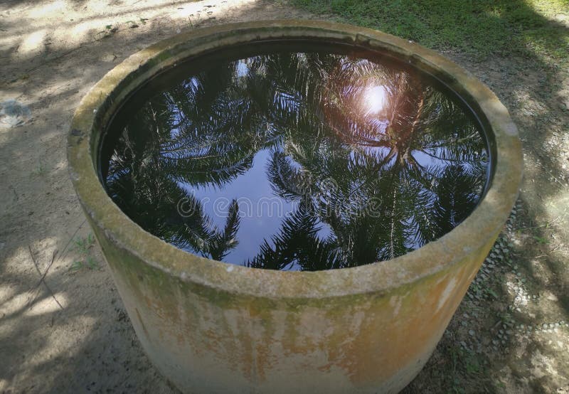 Reflection Scene On The Surface Of The Concrete Well Fill With Water ...