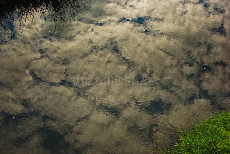 Reflection of the Sky and Clouds in the Flowing River Water . Stock ...