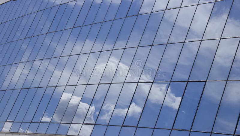 Reflection of the Sky with Clouds in the Glass Windows of the Building ...